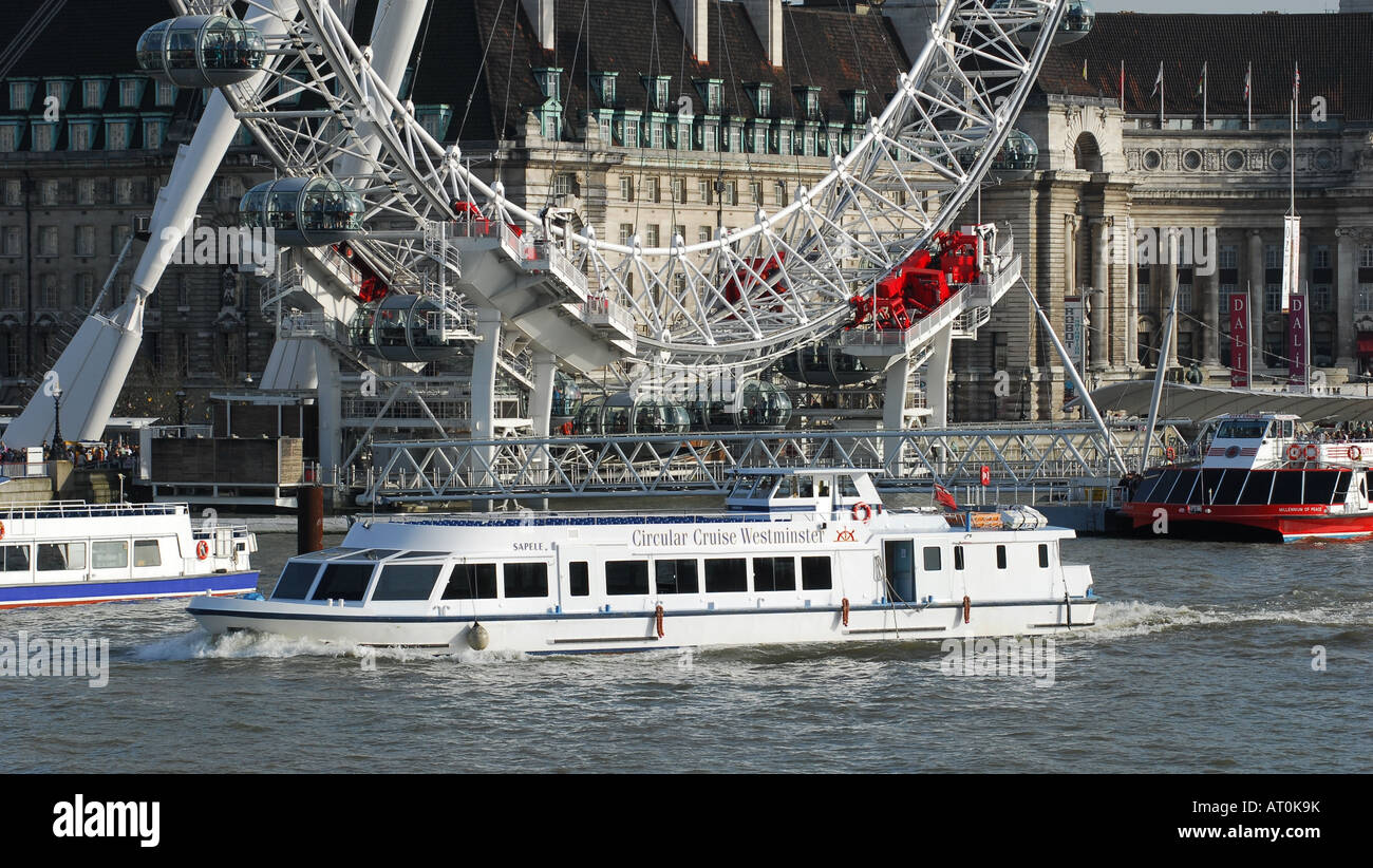 A riverboat on the river Thames in central London, passes the London ...