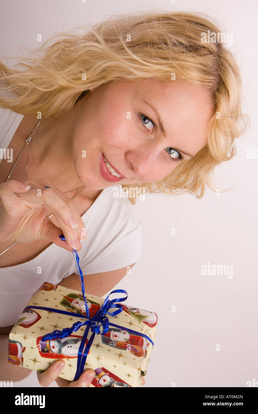 young blonde woman holding present Stock Photo - Alamy