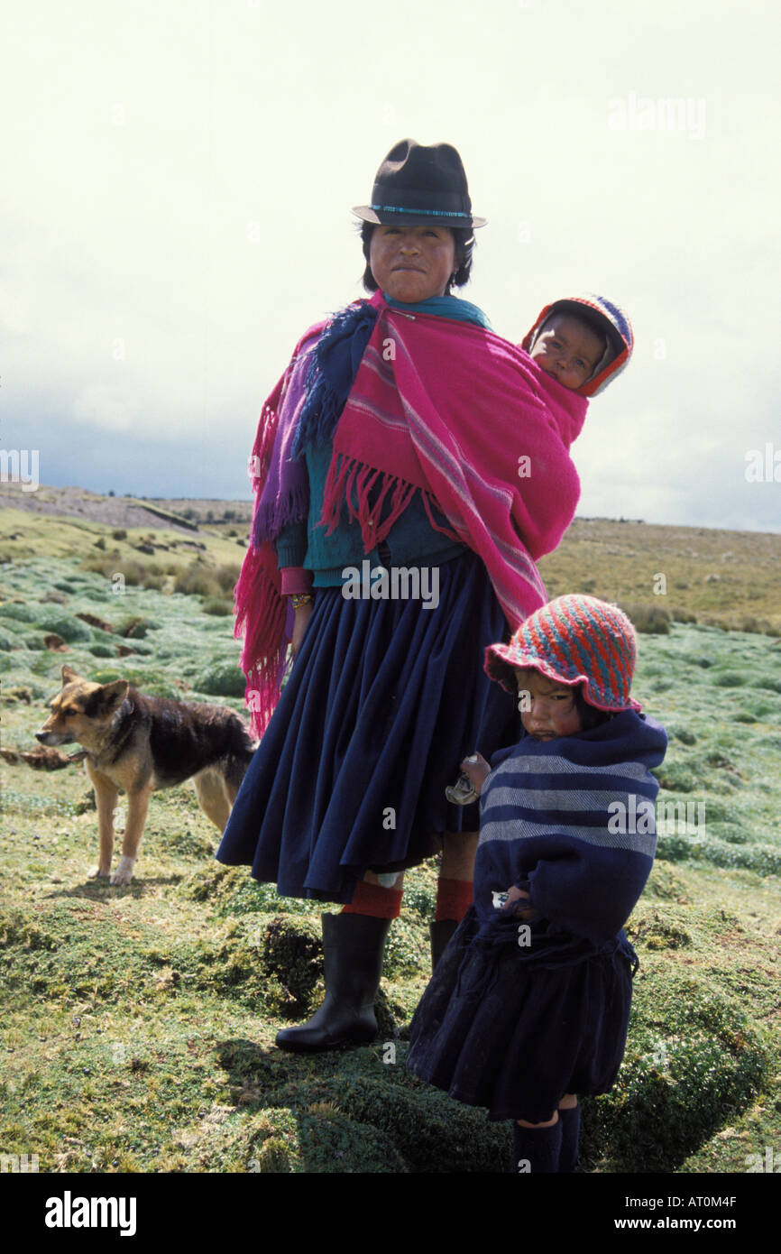 young native South American mother with her two children and a shepherd ...