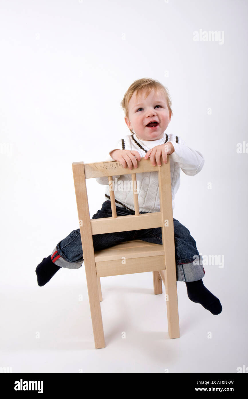 little boy sitting on small chair Stock Photo - Alamy