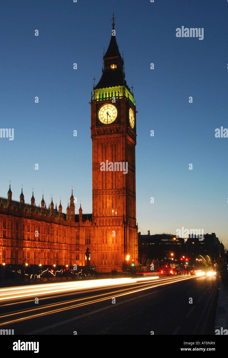 Traffic passes the clock tower of Westminster (Big Ben) in London Stock ...