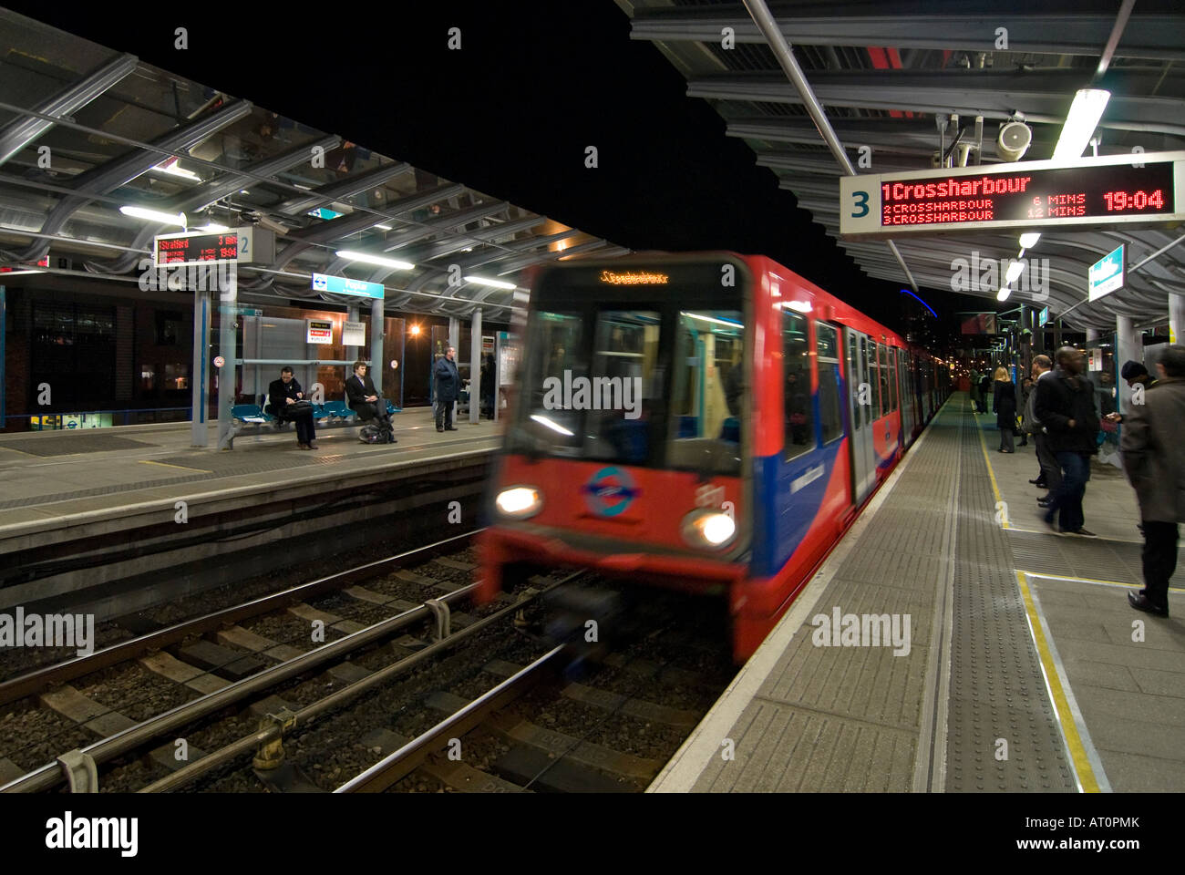 Horizontal wide angle of a Docklands Light Railway train arriving at ...