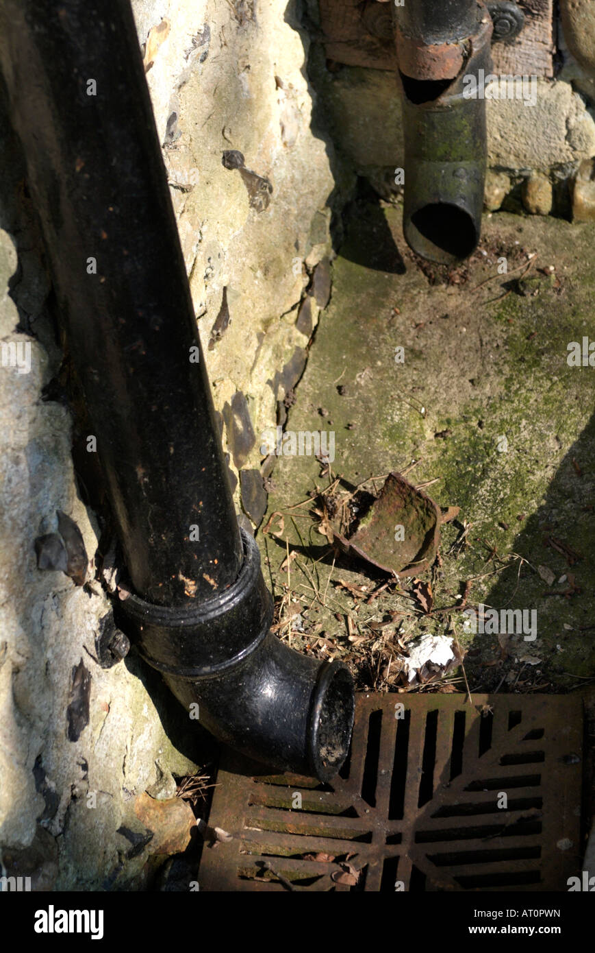 rainwater drainage pipe feeding into iron gulley Stock Photo - Alamy