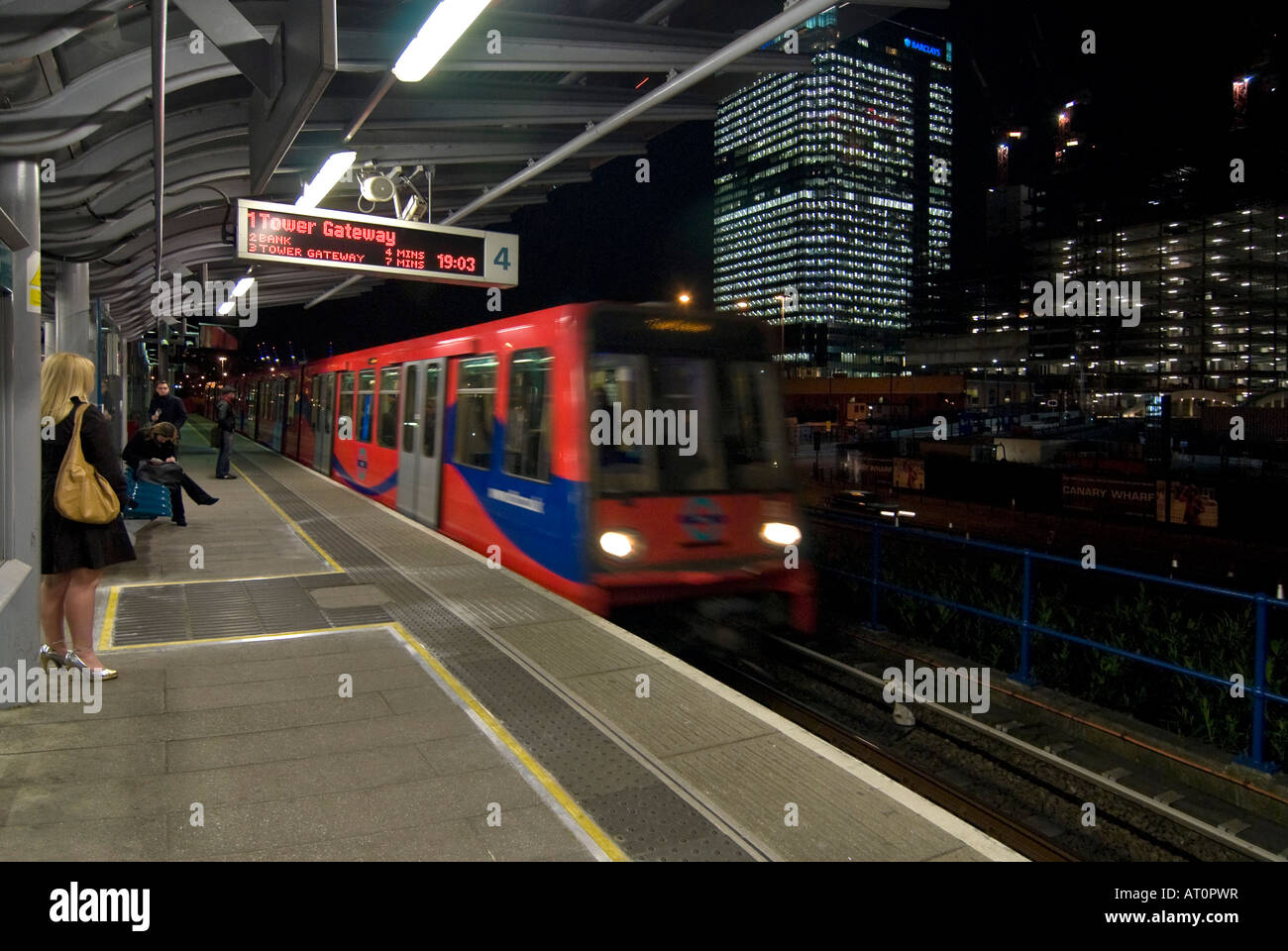 Horizontal wide angle of a Docklands Light Railway train arriving at ...