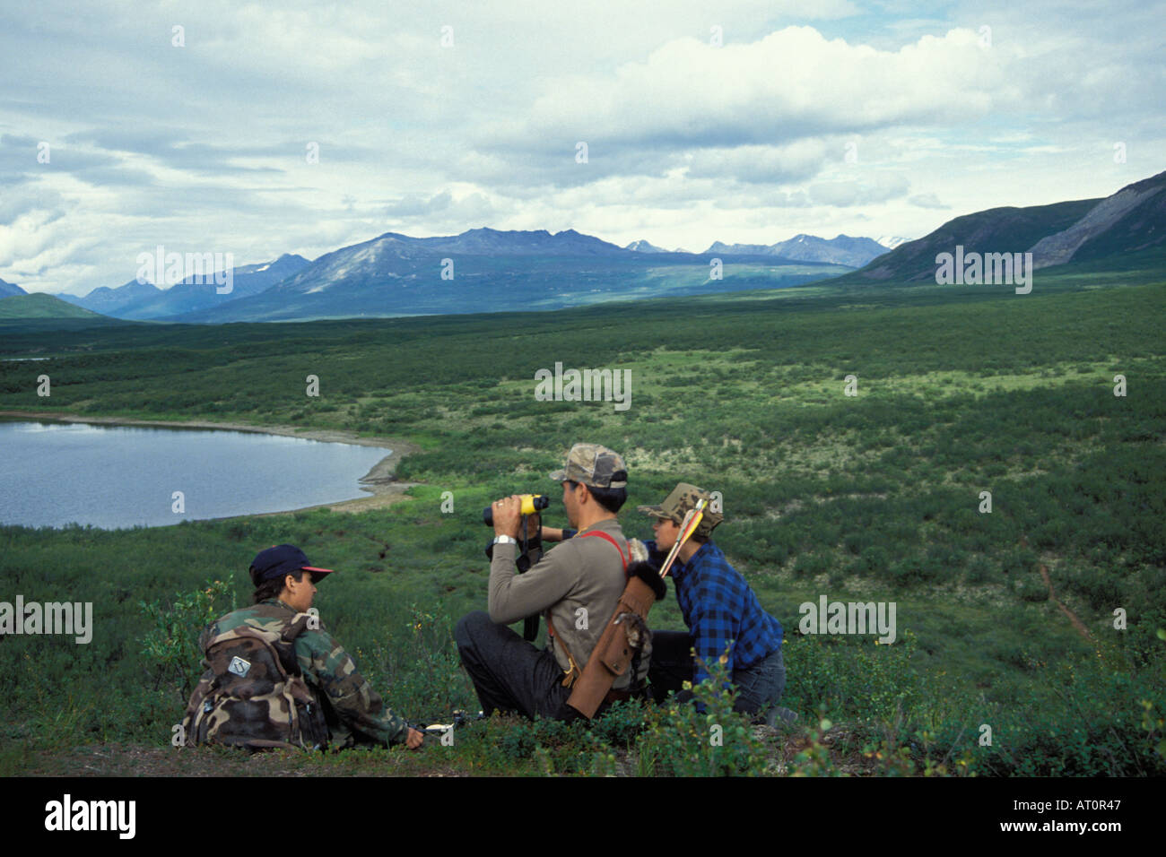 native caribou hunter with his two children during the early fall hunt ...