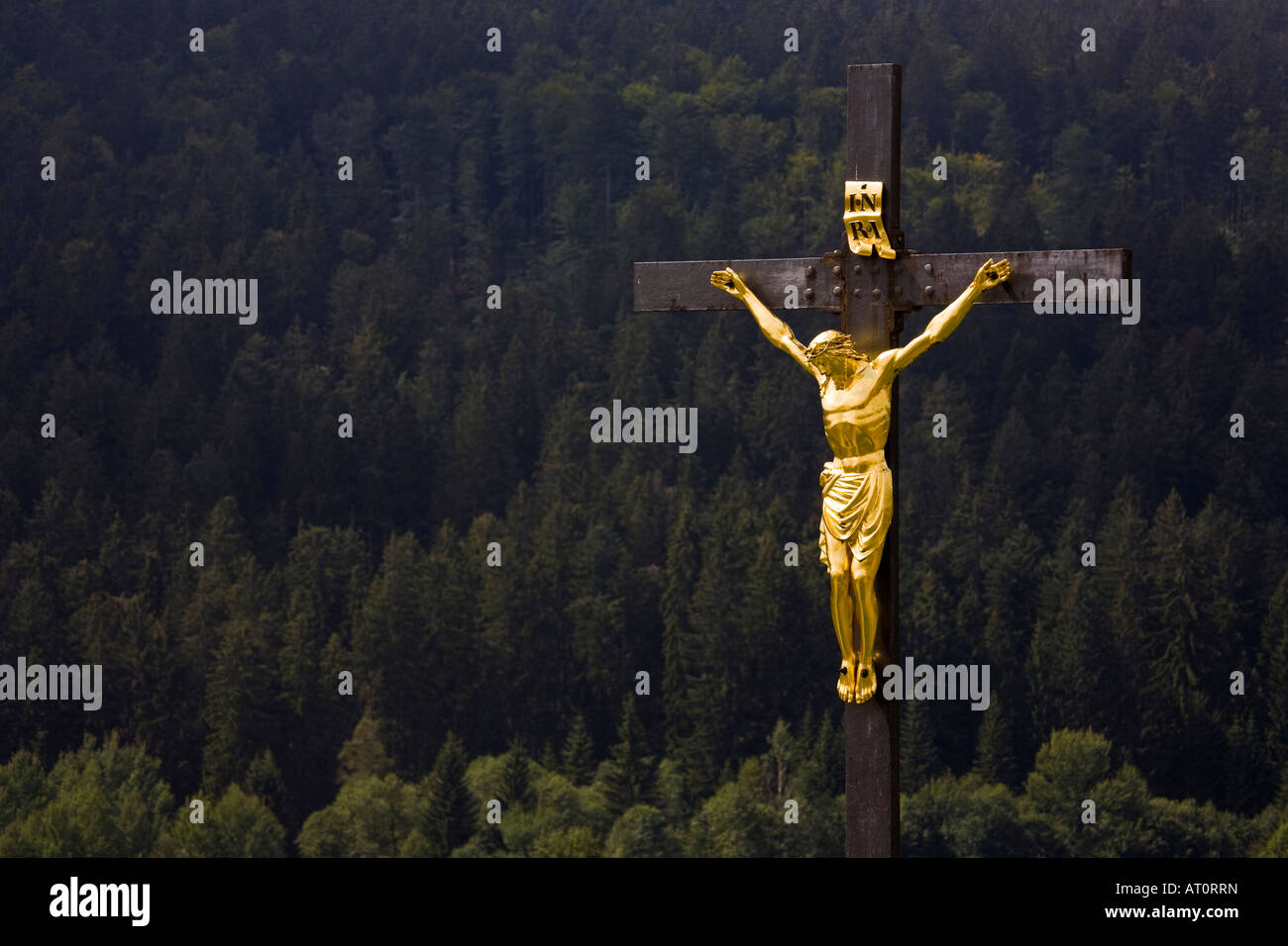 Figure of Christ on cross against backdrop of forest trees Mauth ...