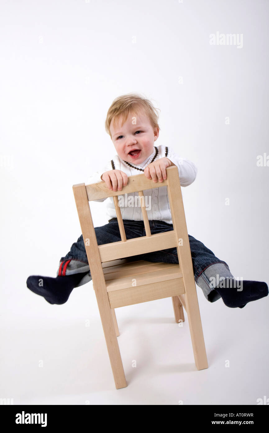 little boy sitting on small chair Stock Photo - Alamy