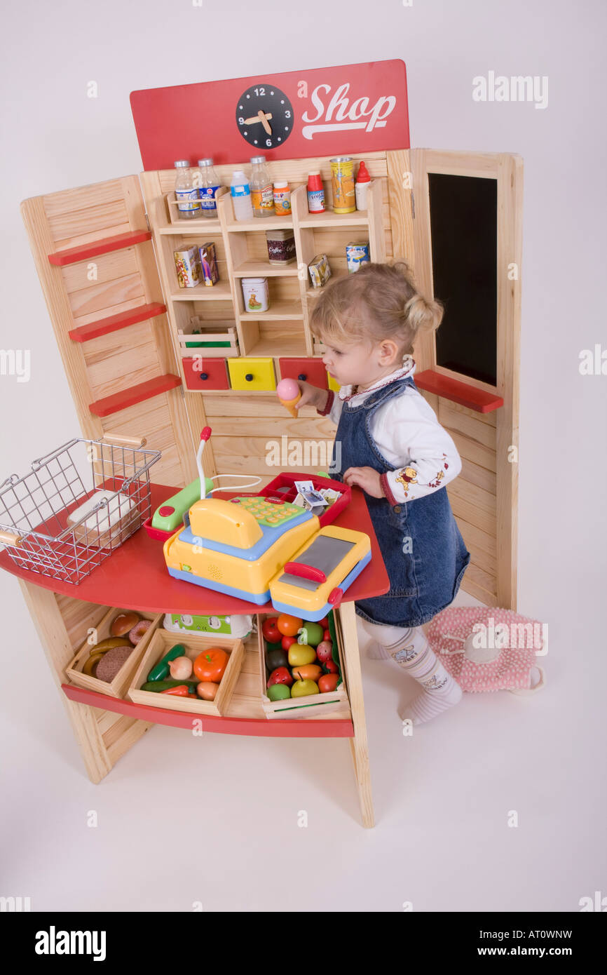 little girl playing in grocery shop for children Stock Photo - Alamy