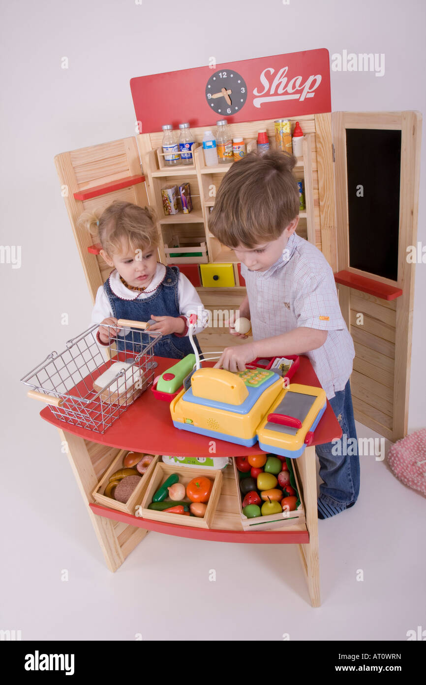 little boy and little girl playing in grocery shop for children Stock ...