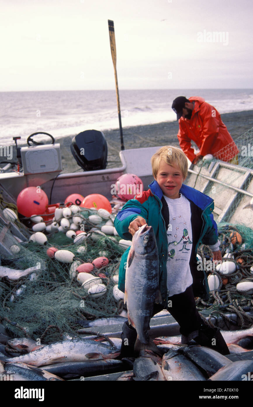 Andy Kircher son of a commercial set net fisherman holds up a Kenai ...