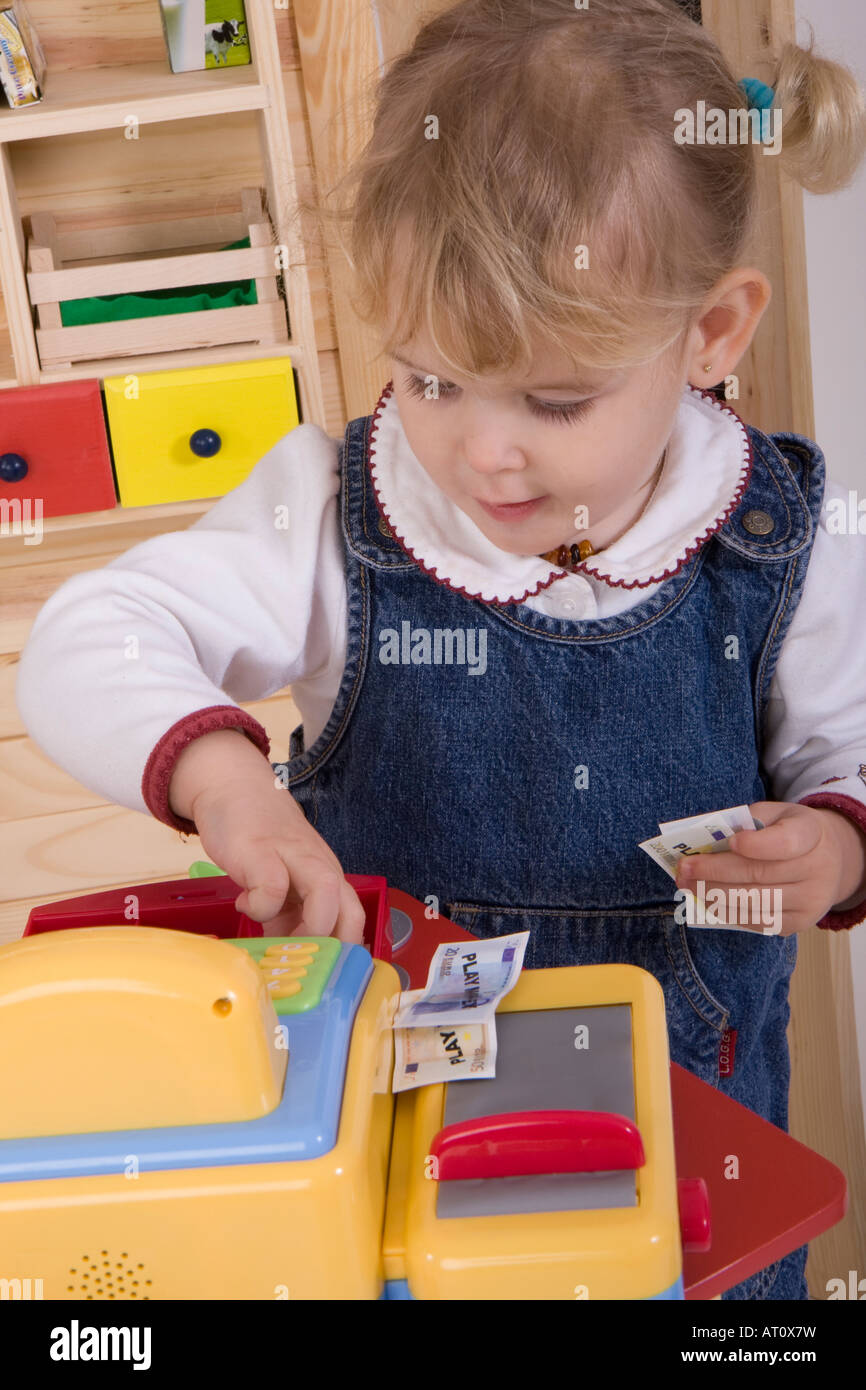 little girl playing in grocery shop for children Stock Photo - Alamy
