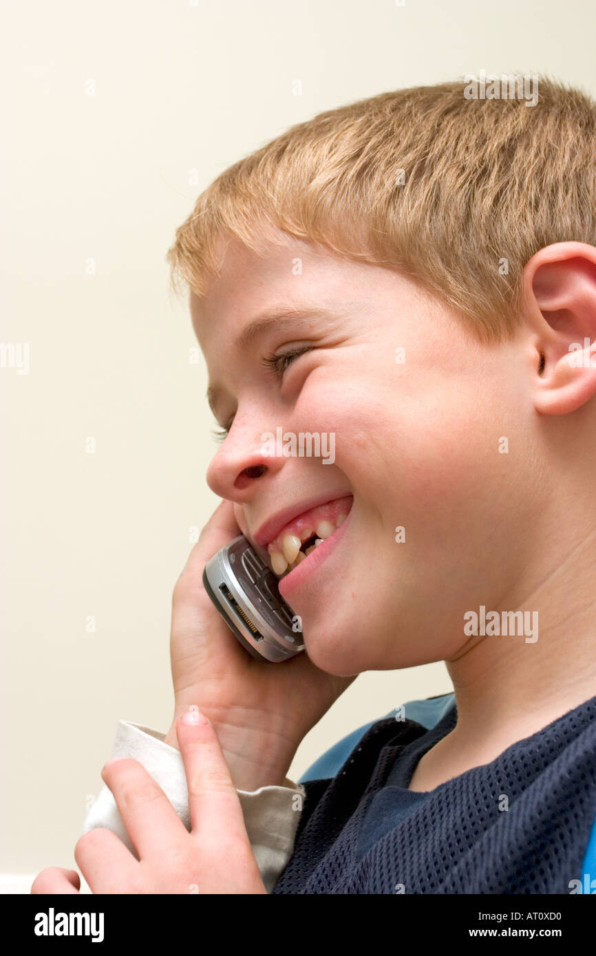 Young boy smiling using mobile phone Stock Photo - Alamy