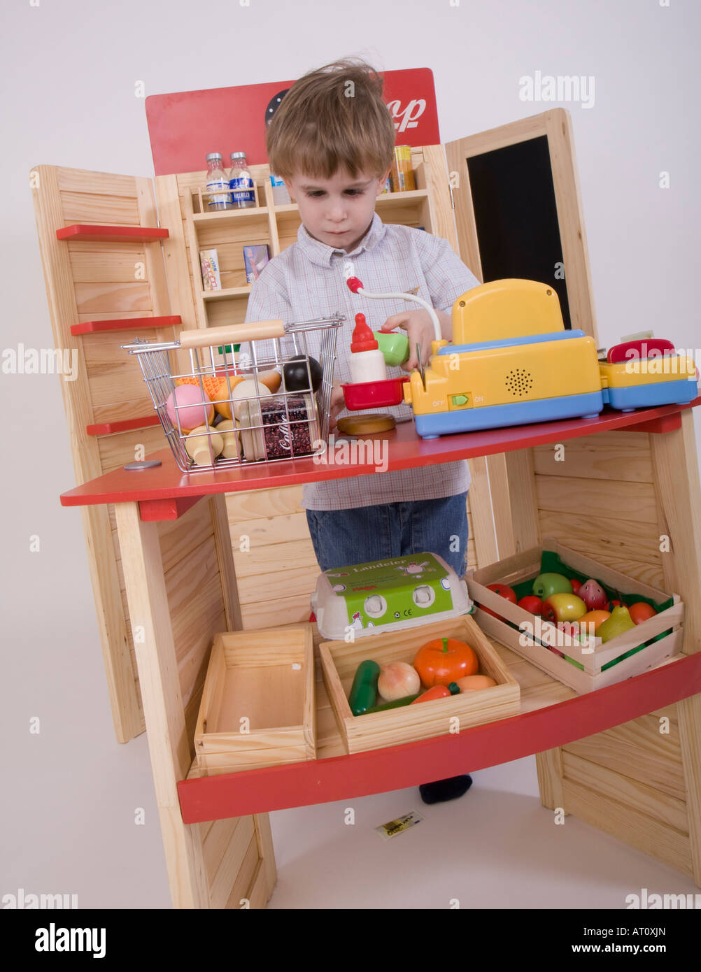 little boy playing in grocery shop for children Stock Photo - Alamy