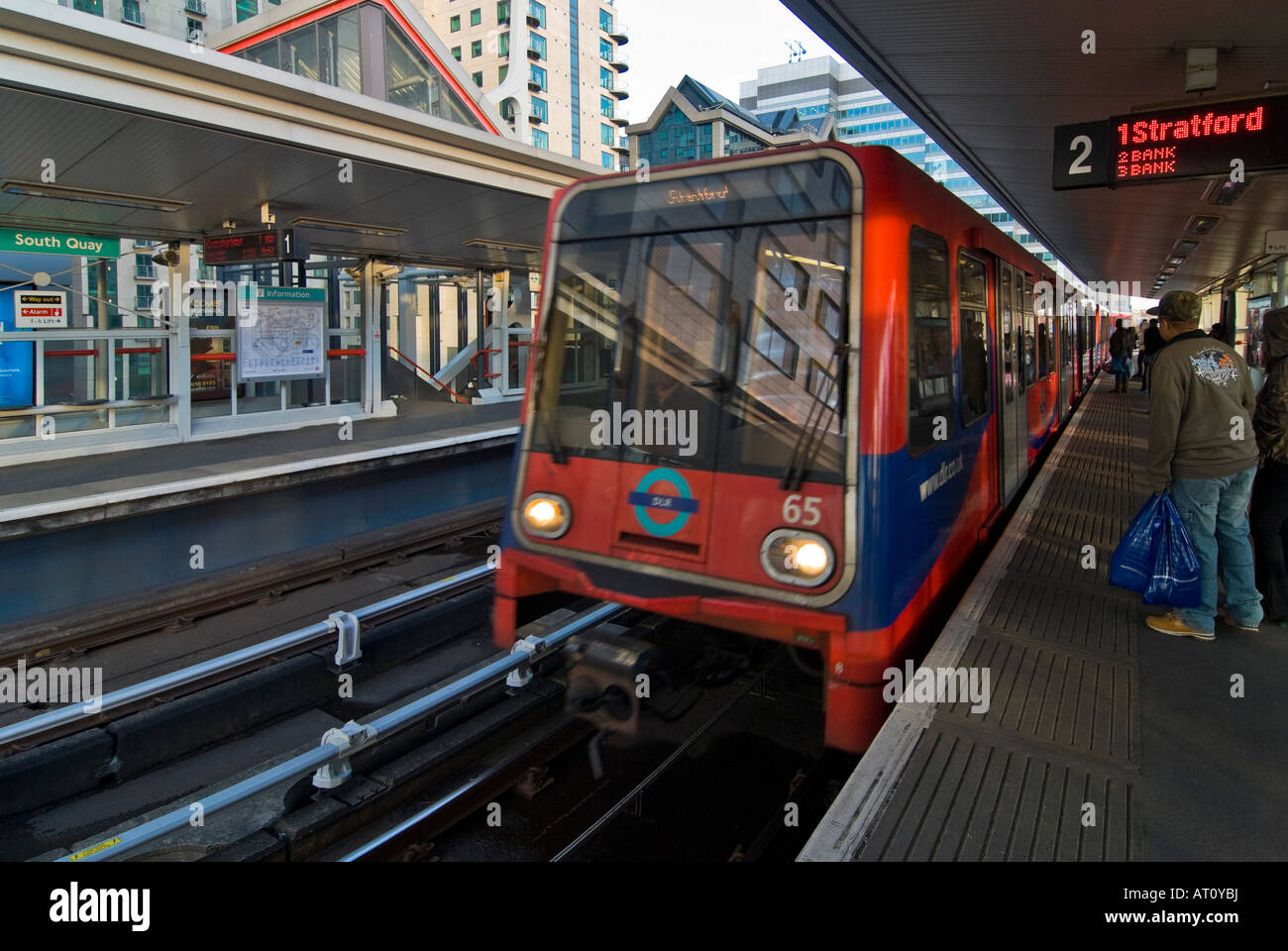 Horizontal wide angle of a Docklands Light Railway train pulling into ...