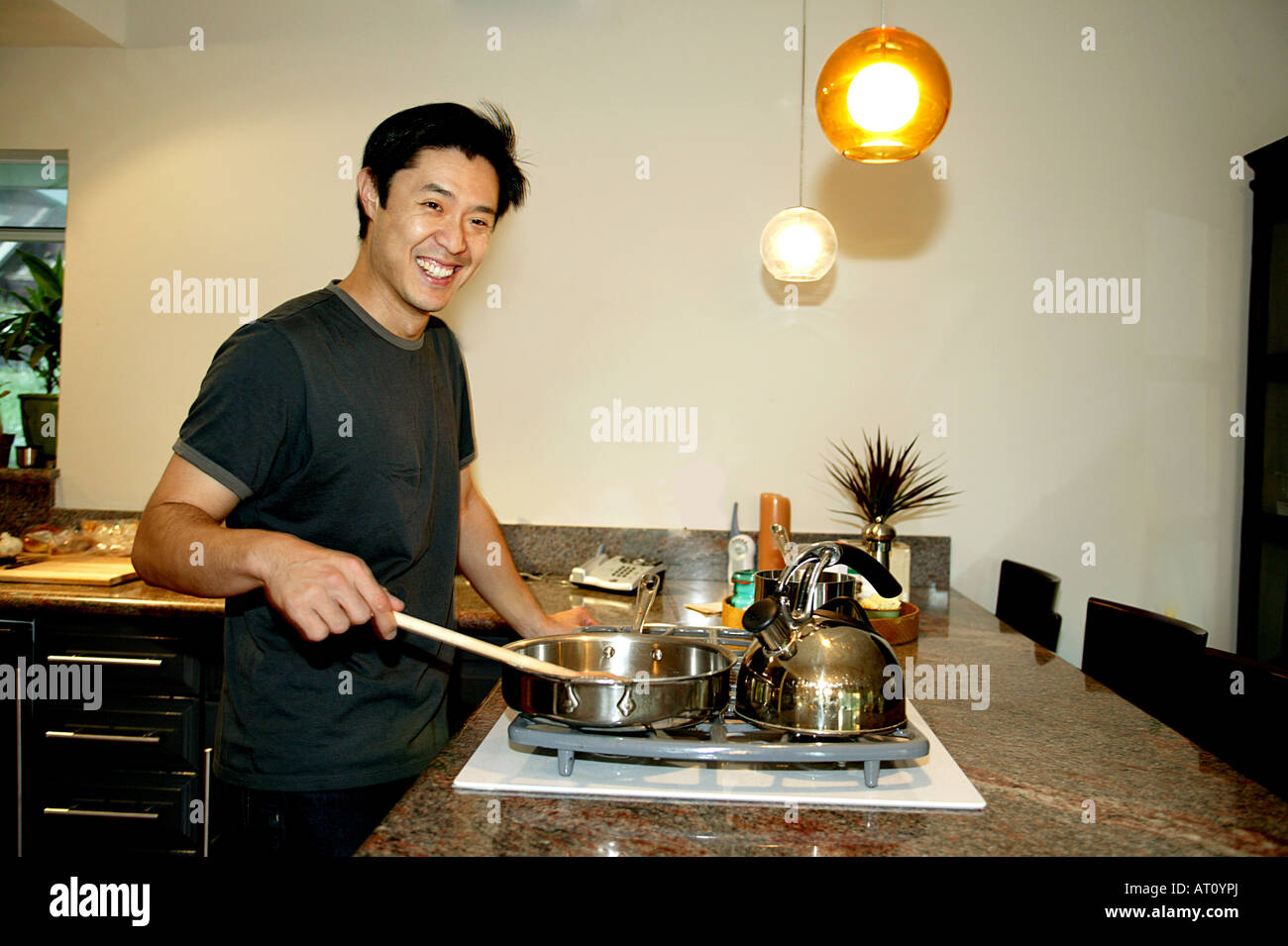 Modern kitchens man hi-res stock photography and images - Alamy