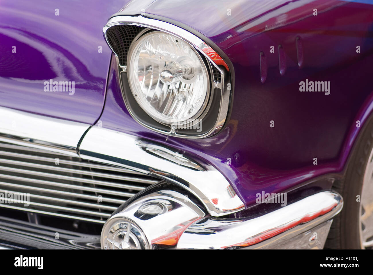detail photo of front headlight of purple 1957 chevrolet classic car ...