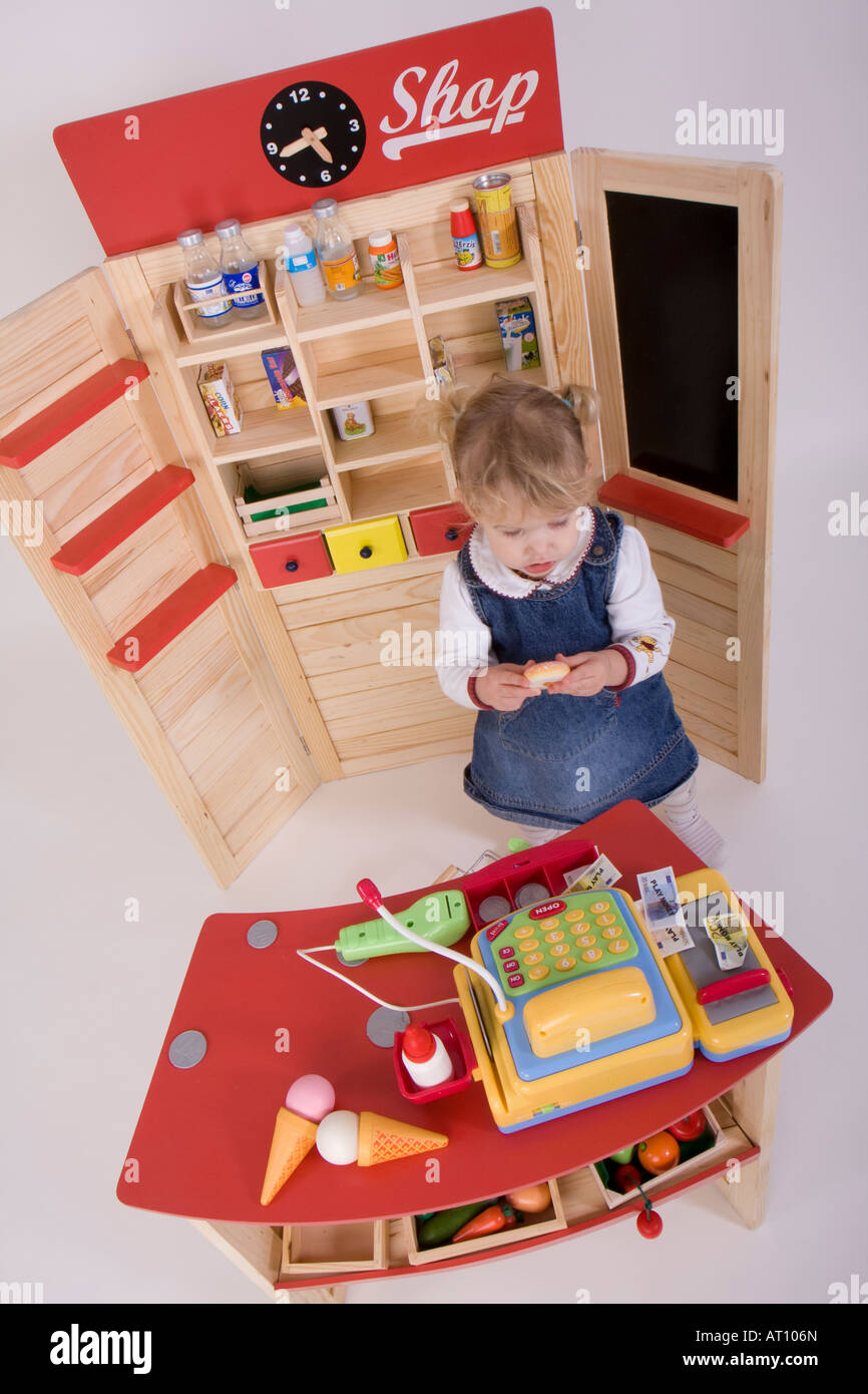 little girl playing in grocery shop for children Stock Photo - Alamy