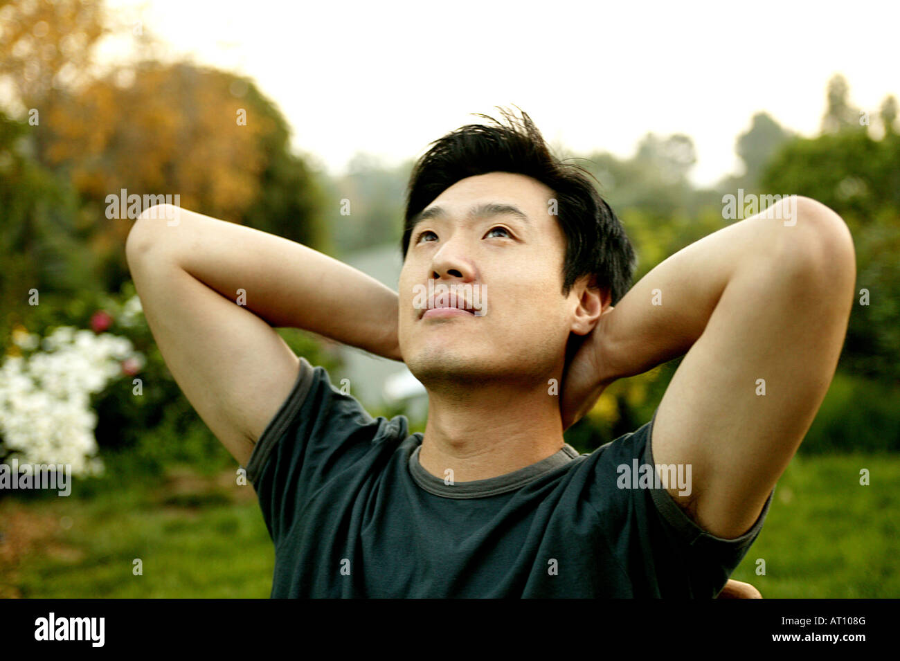 Man Outside, Hands Behind Head Stock Photo - Alamy