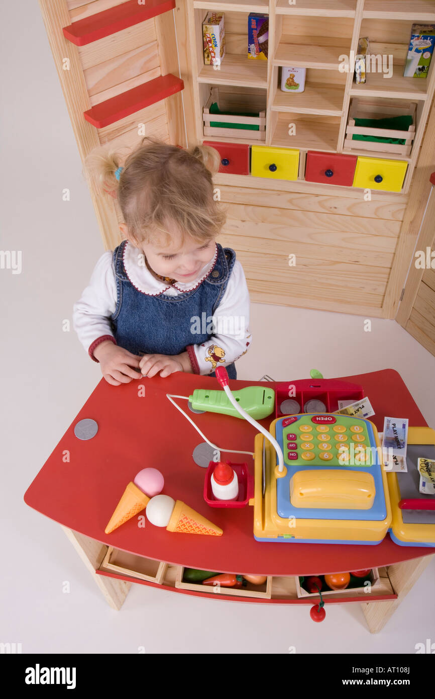 little girl playing in grocery shop for children Stock Photo - Alamy