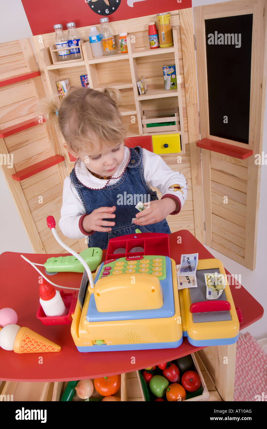 little girl playing in grocery shop for children Stock Photo - Alamy