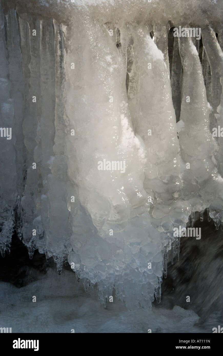 Ice formations above flowing water on the banks of an Ontario stream in ...