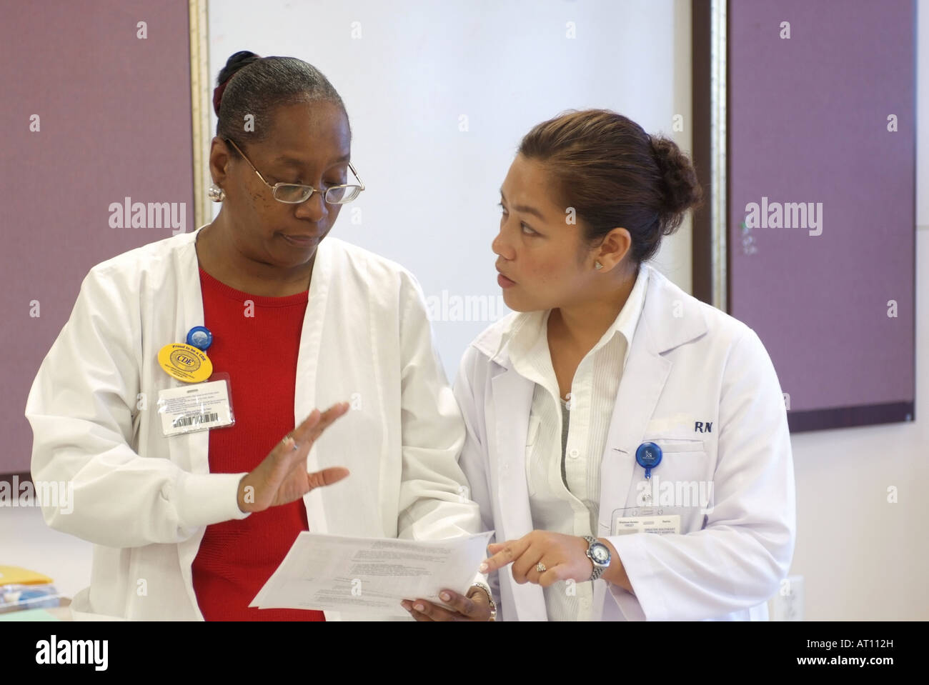 Heath Care Two nurses talk in classroom Stock Photo - Alamy