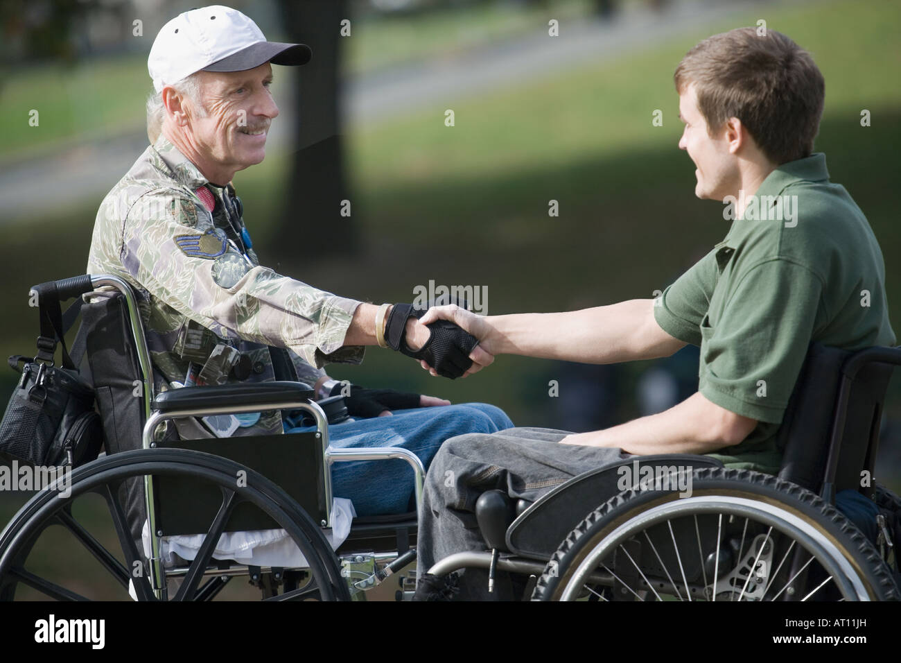 Two war veterans shaking hands with each other Stock Photo - Alamy
