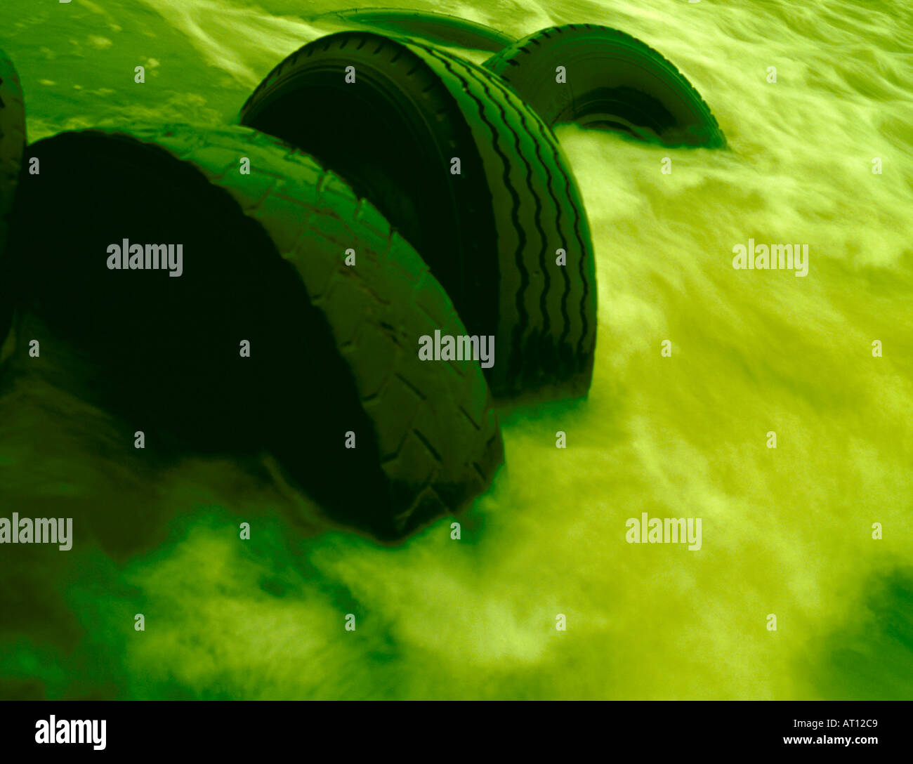 River pollution; old car tyres dumped in a river Stock Photo - Alamy