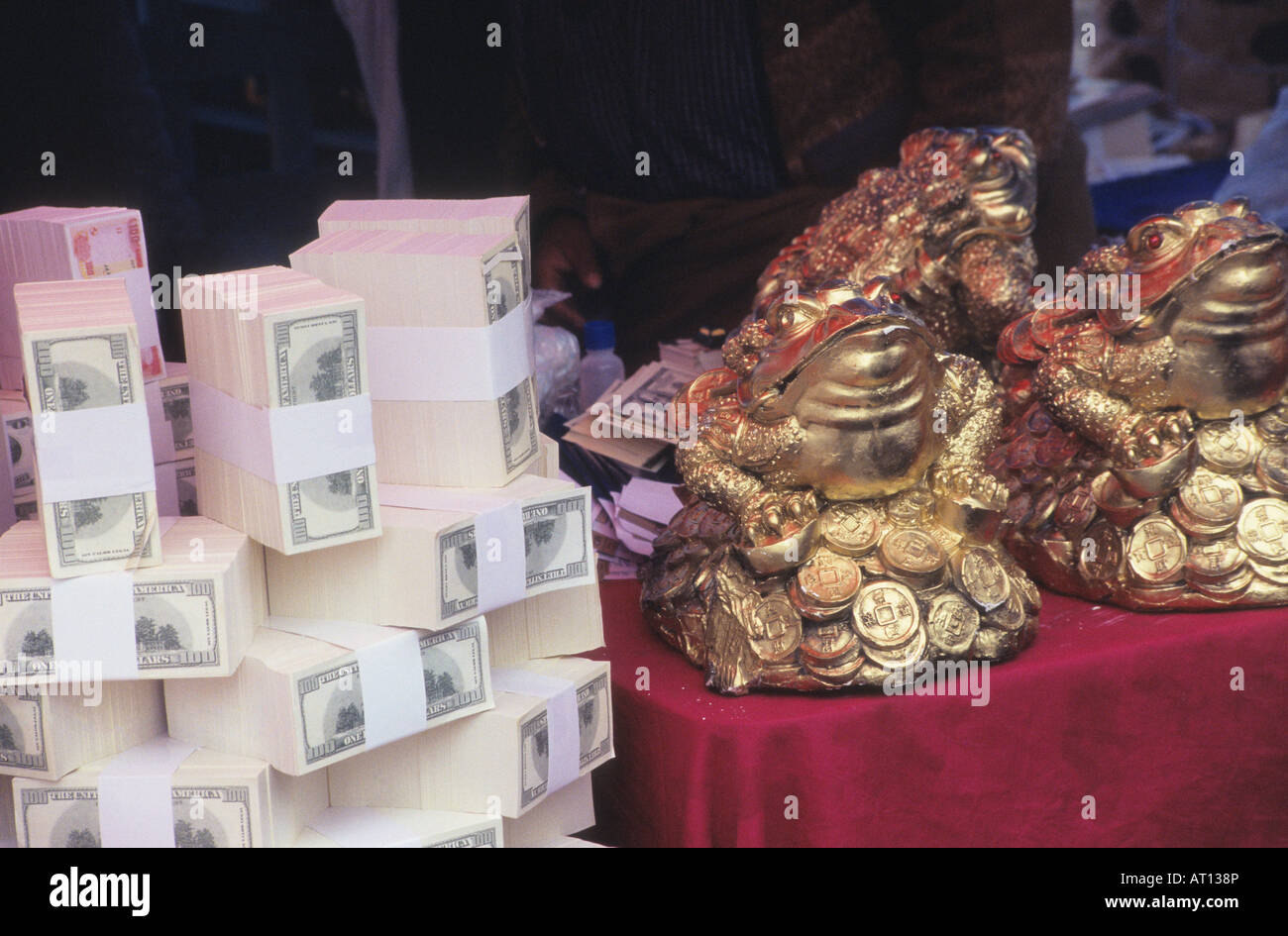 Miniature blocks of $100 dollar bills and golden Chinese Jin Chan money ...