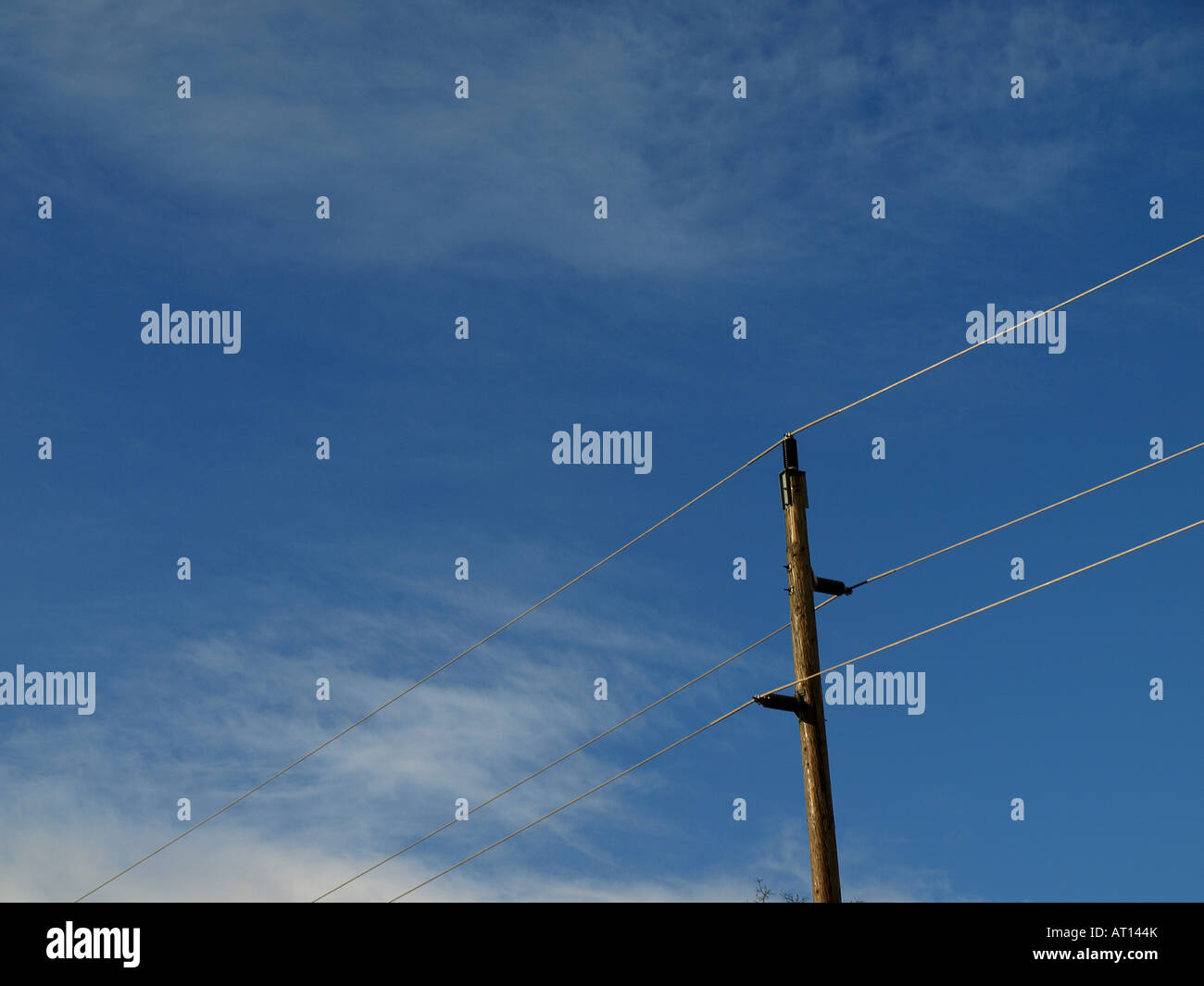 A power pole with a bright blue sky Stock Photo - Alamy