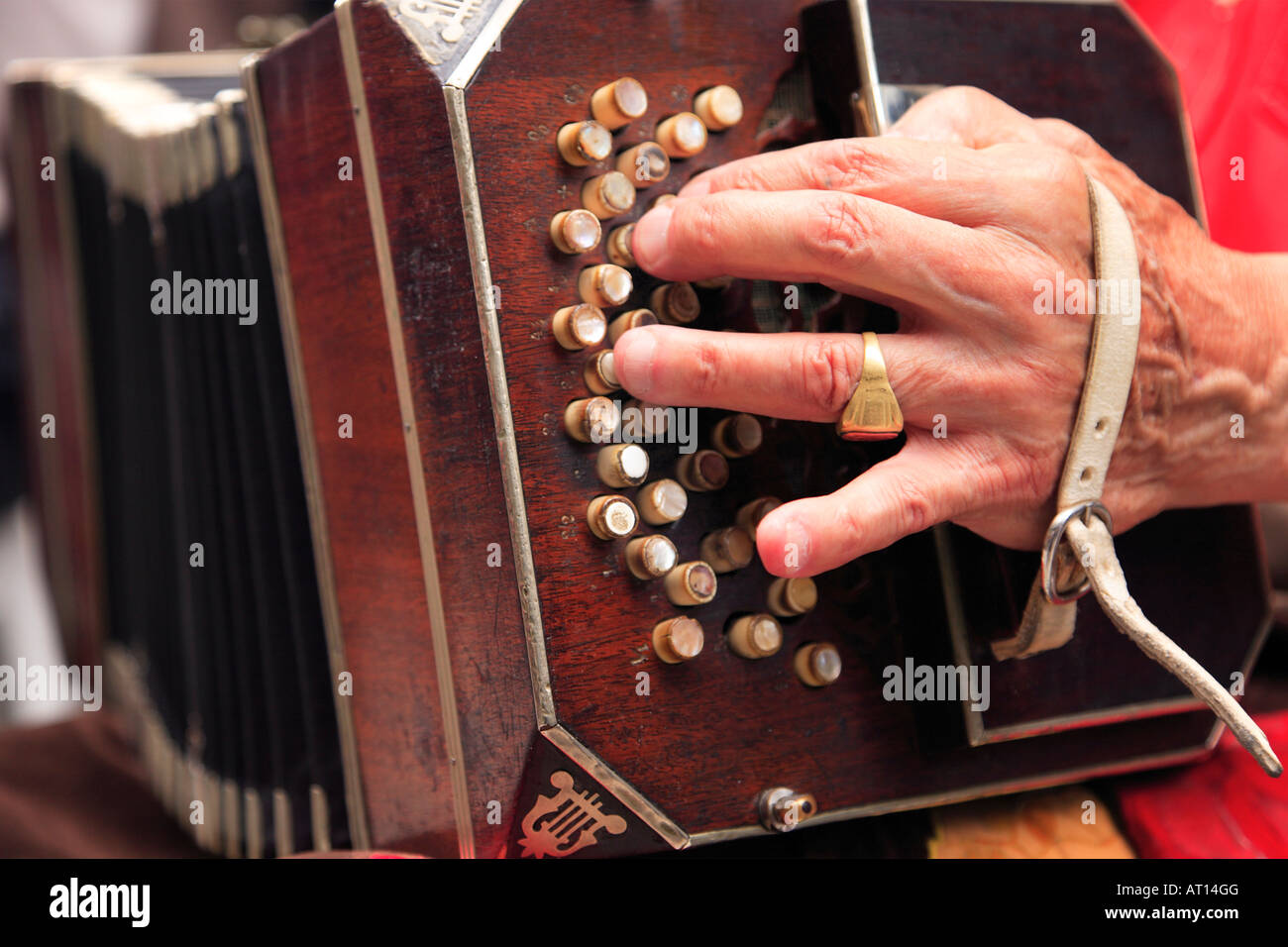Close-up of Old musician hand playing a tango with a “bandoneon” at ...