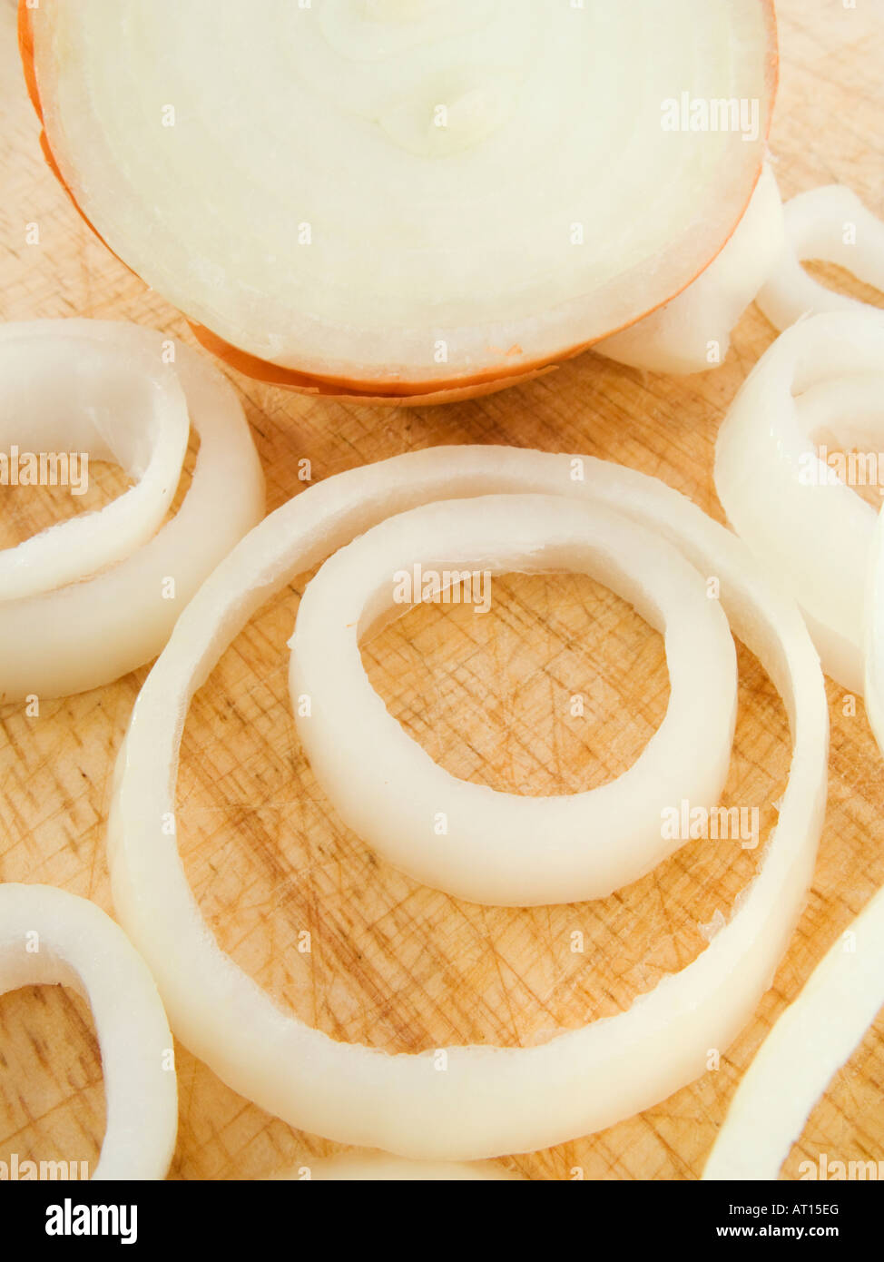 Onion rings over a kitchen wood board Stock Photo - Alamy