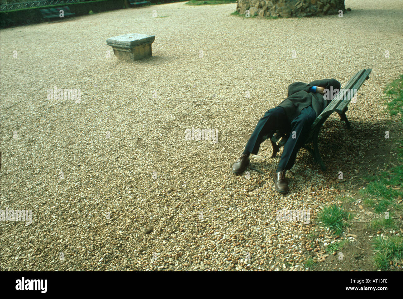 man lying on park bench Stock Photo - Alamy