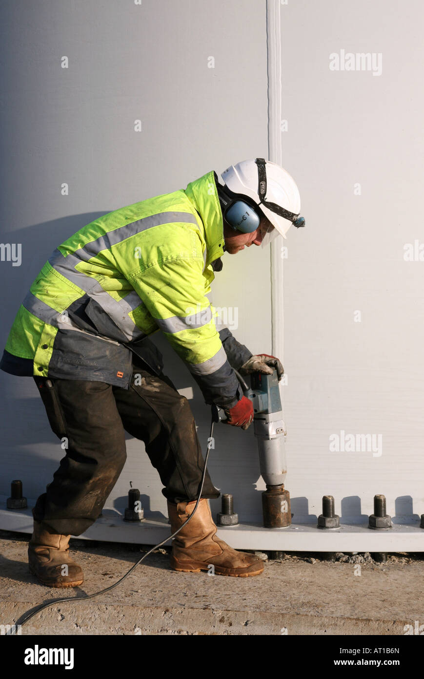 Workman securing foundation tower bolts, with torque wrench, at the ...