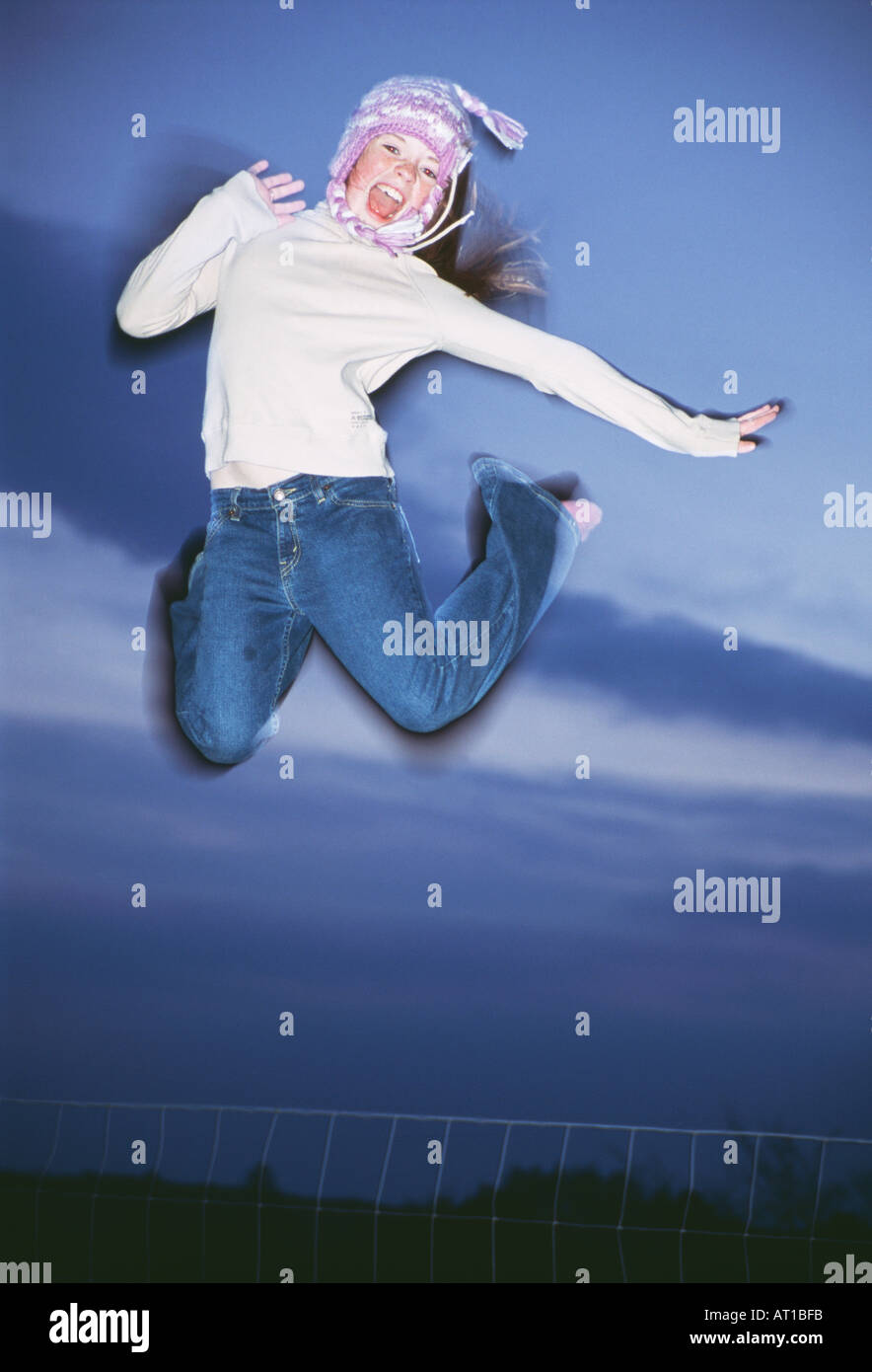 Smiling girl jumping on trampoline hi-res stock photography and images ...