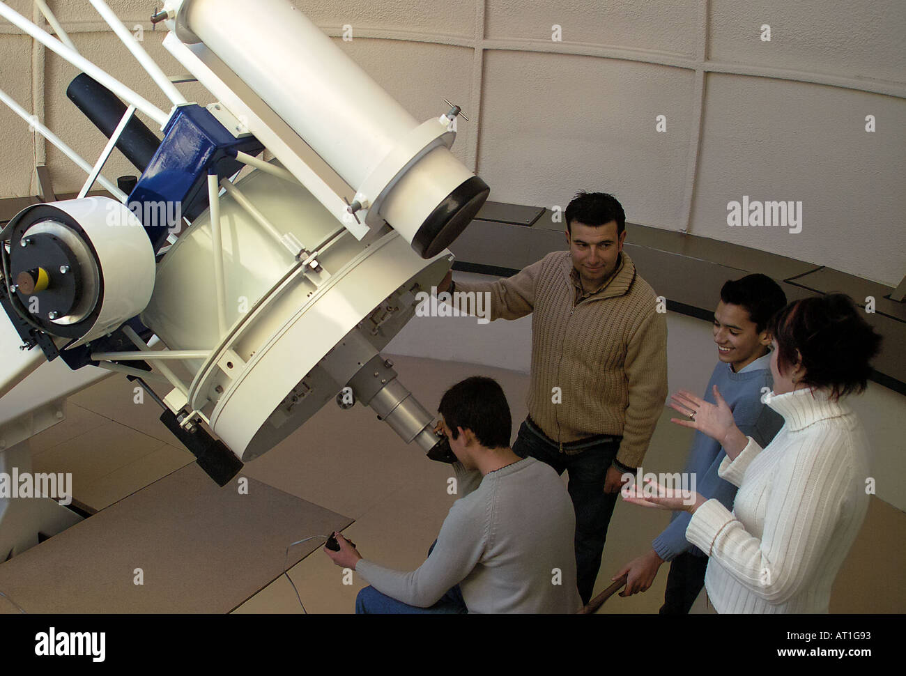 Family watching the skies with telescope Stock Photo - Alamy