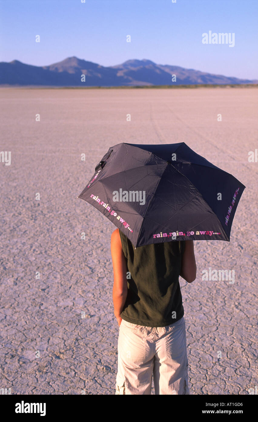 Woman standing with umbrella on the Black Rock Desert playa Nevada USA ...