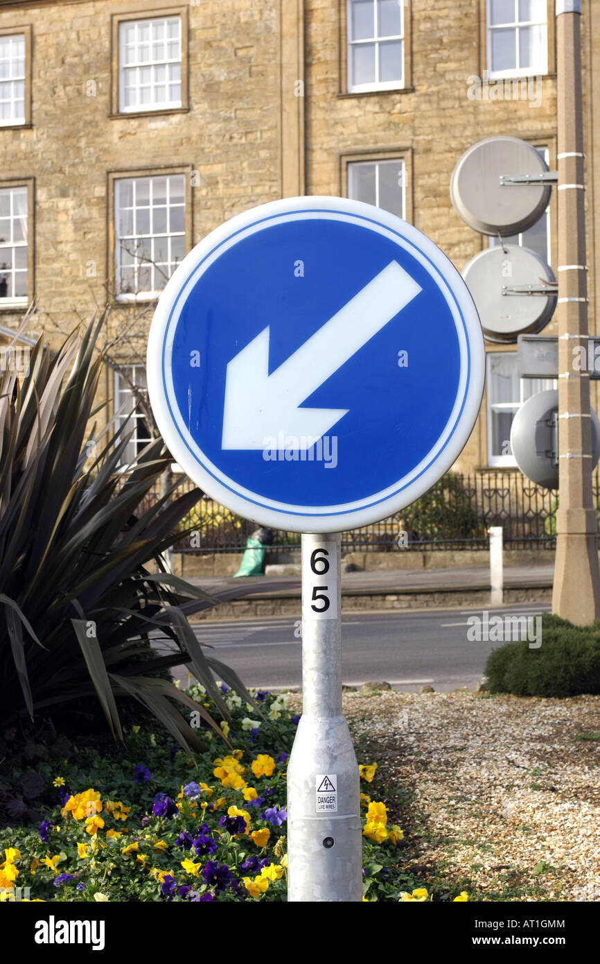 Keep Left road sign arrow at a traffic island in England Stock Photo ...