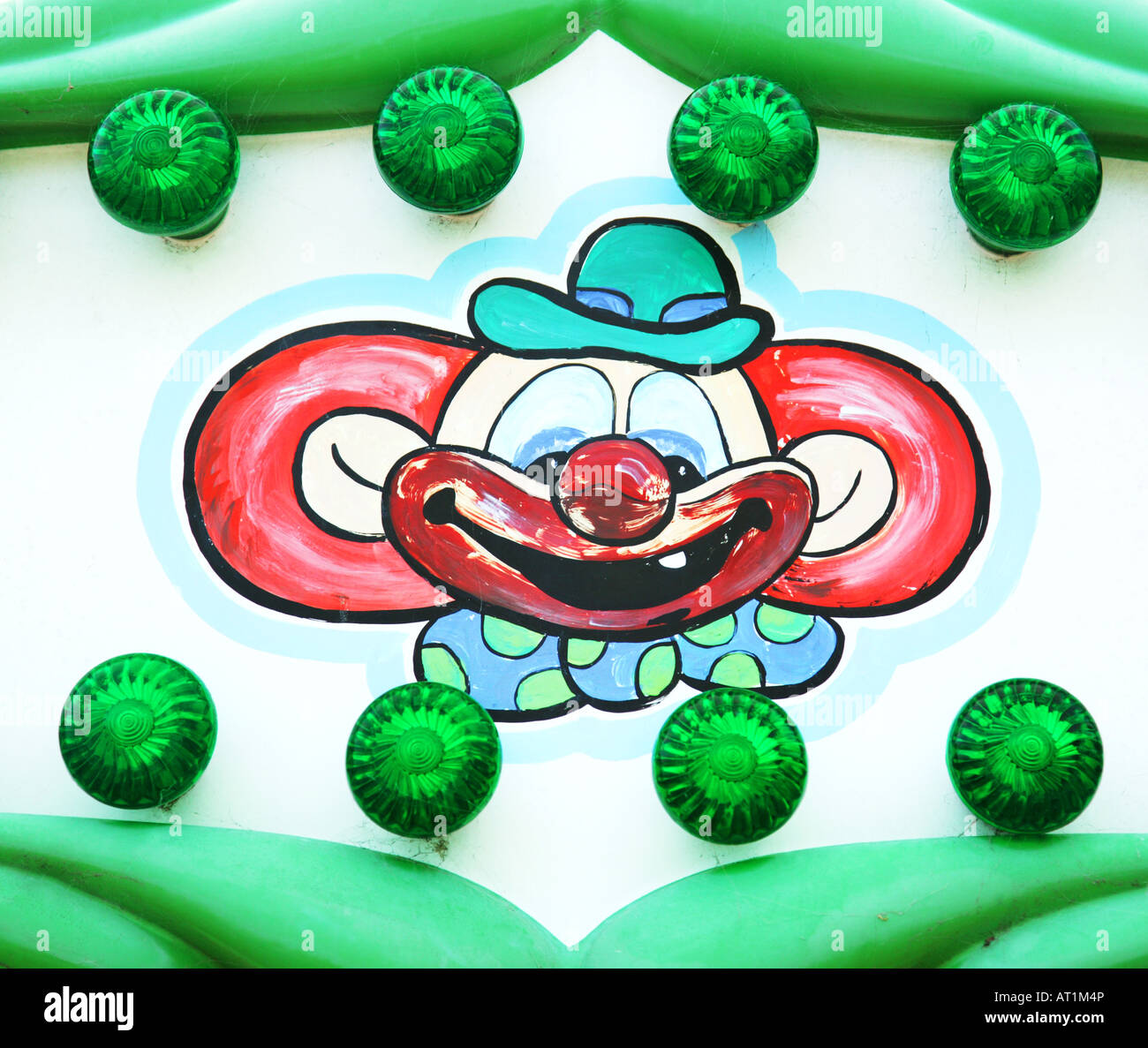 Clown detail from a merry go round under a blue sky Stock Photo - Alamy