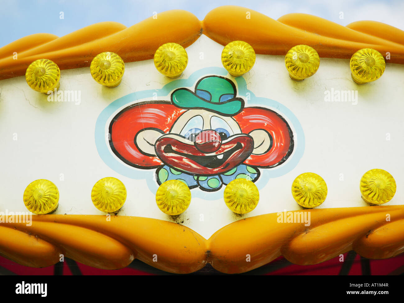 Clown detail from a merry go round under a blue sky Stock Photo - Alamy