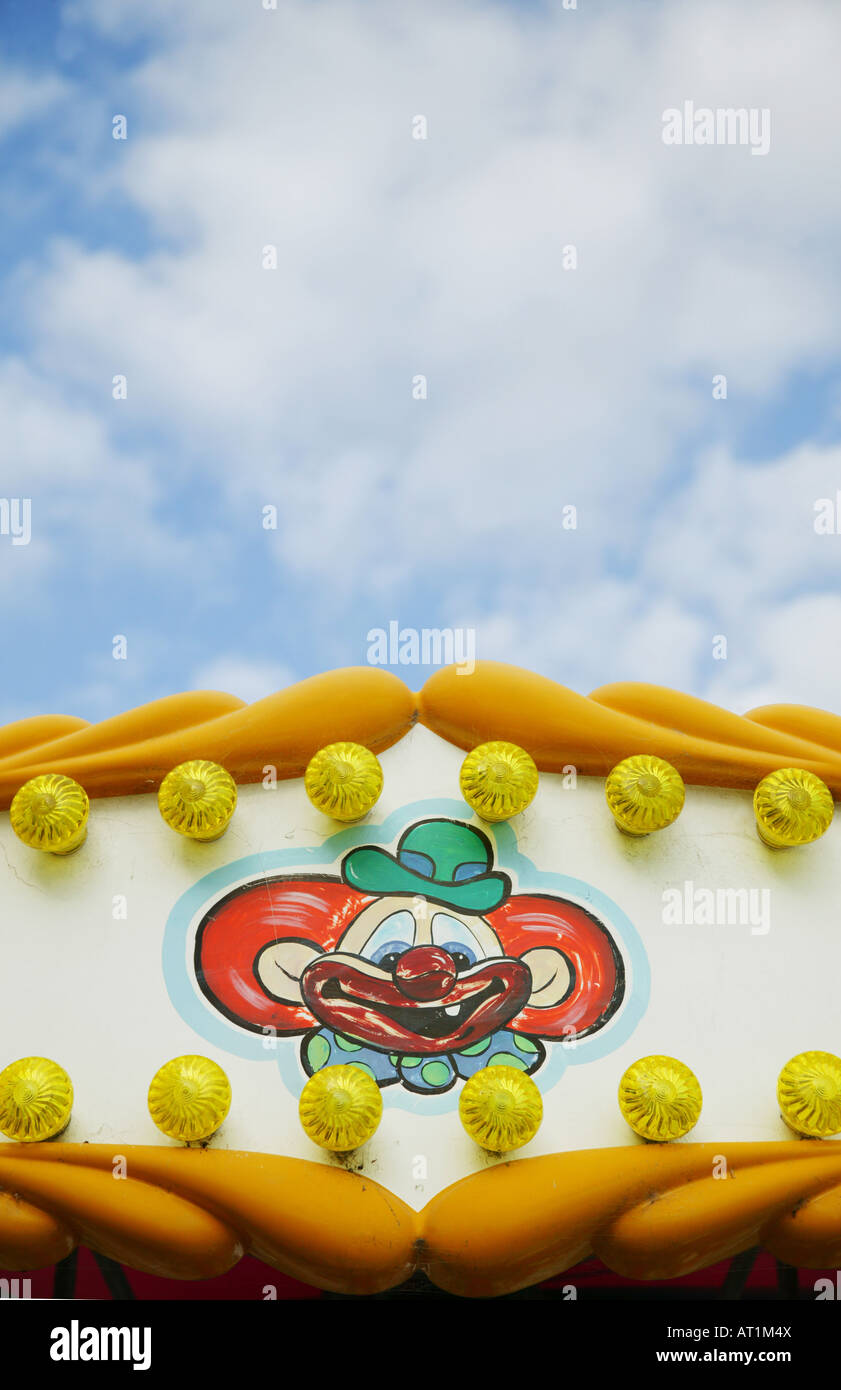Clown detail from a merry go round under a blue sky Stock Photo - Alamy
