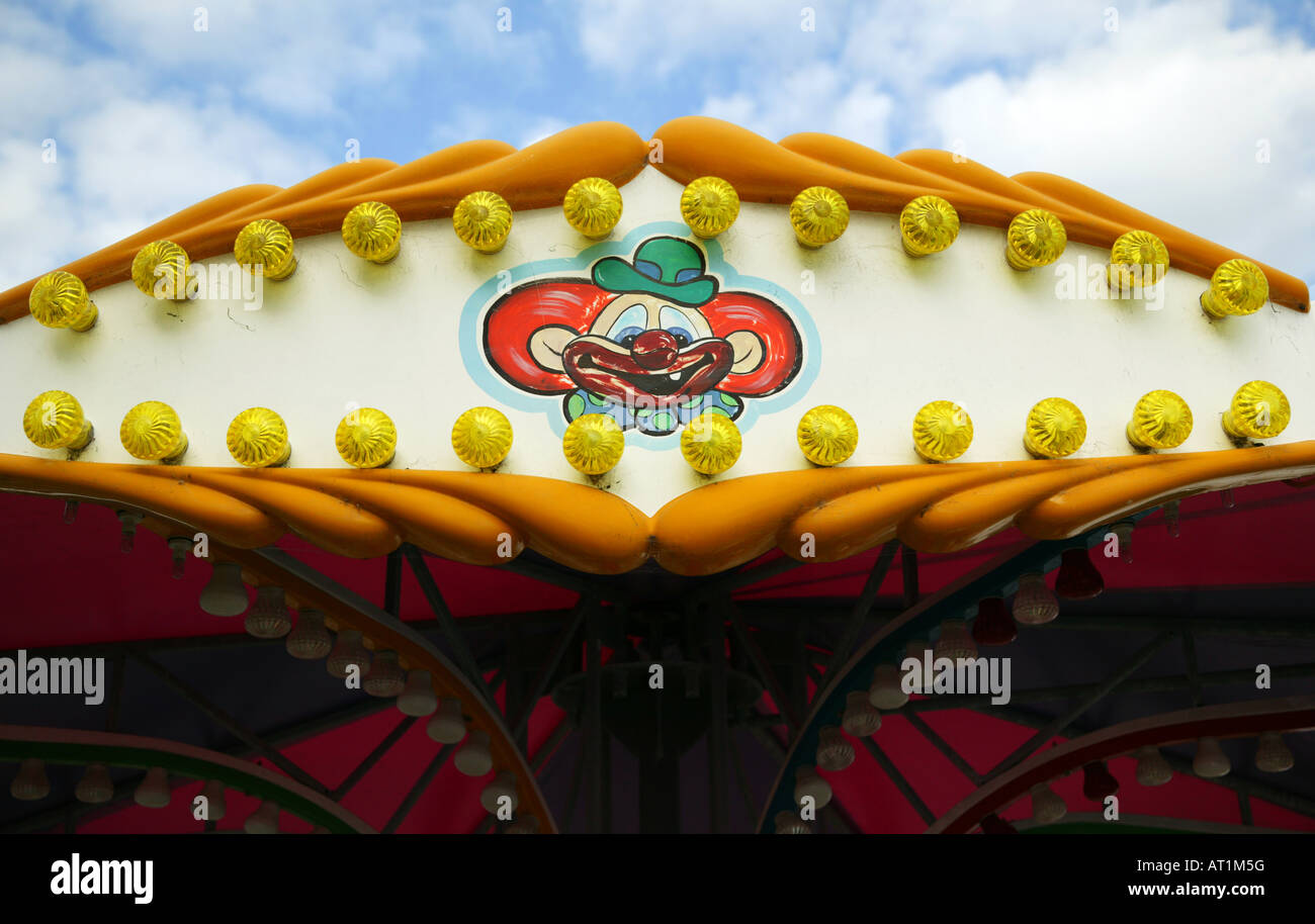Clown detail from a merry go round under a blue sky Stock Photo - Alamy
