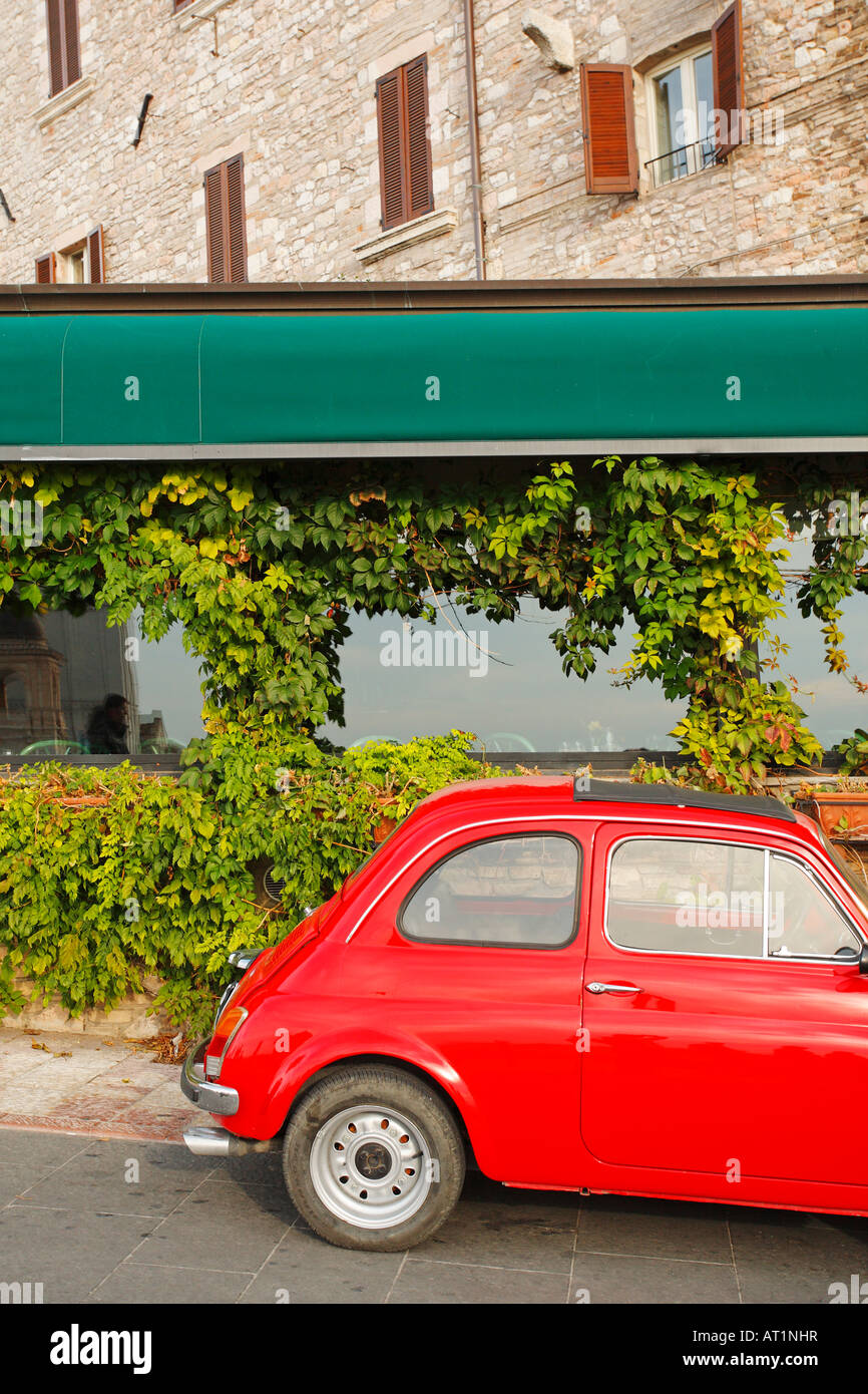 Small red car parked on the street in Assisi, Italy Stock Photo - Alamy