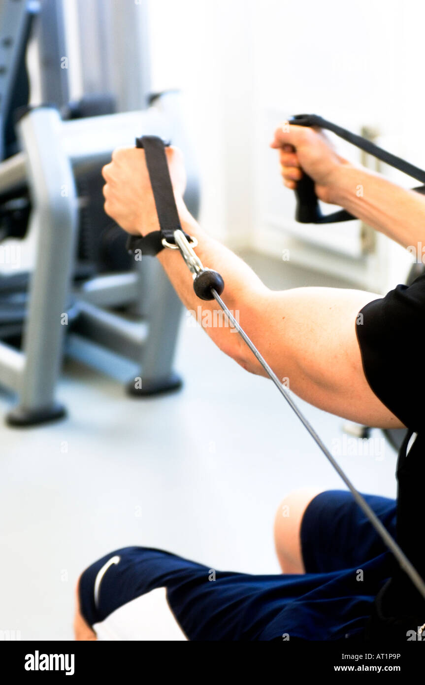 Man Training with Weights on a Gym Machine Stock Photo - Alamy