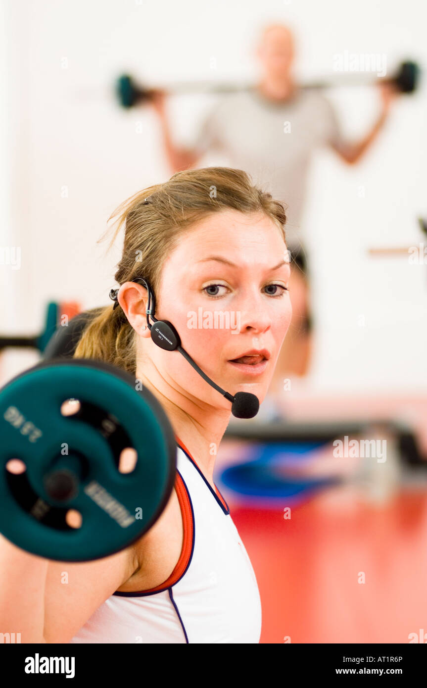 Female aerobics trainer showing bodytoning with light weights Stock ...
