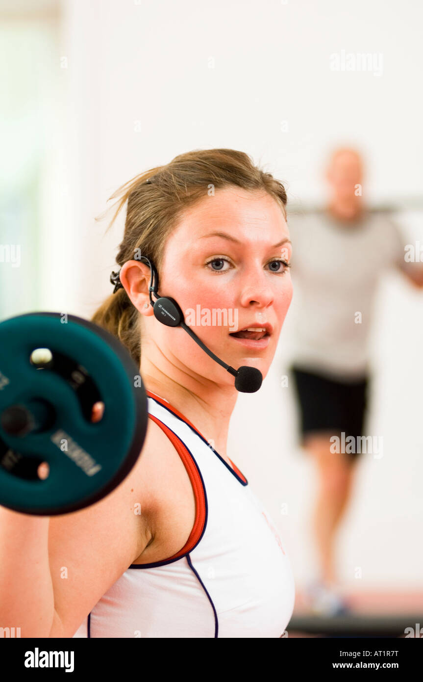 Female aerobics trainer showing bodytoning with light weights Stock ...