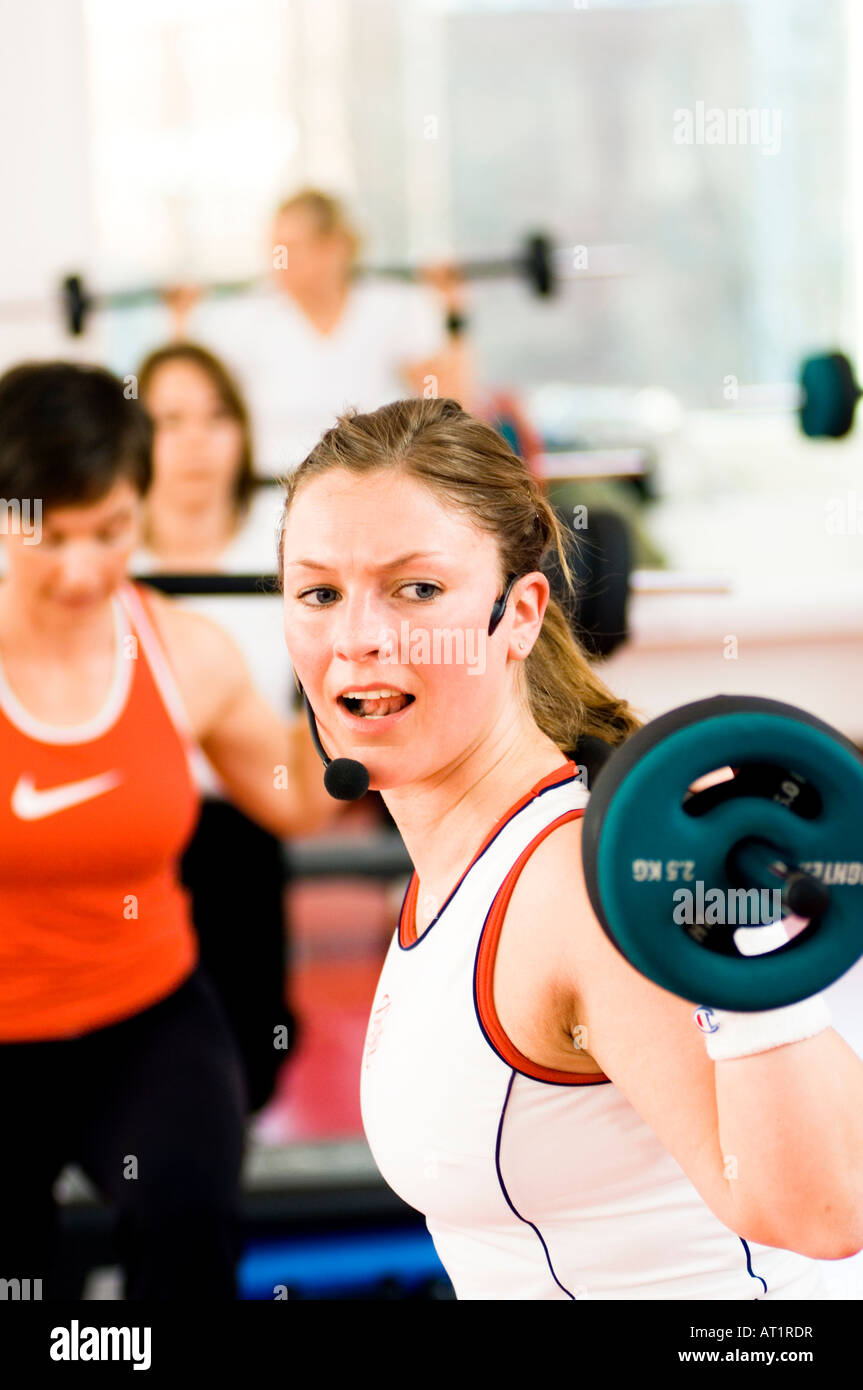 Female aerobics trainer showing bodytoning with light weights Stock ...
