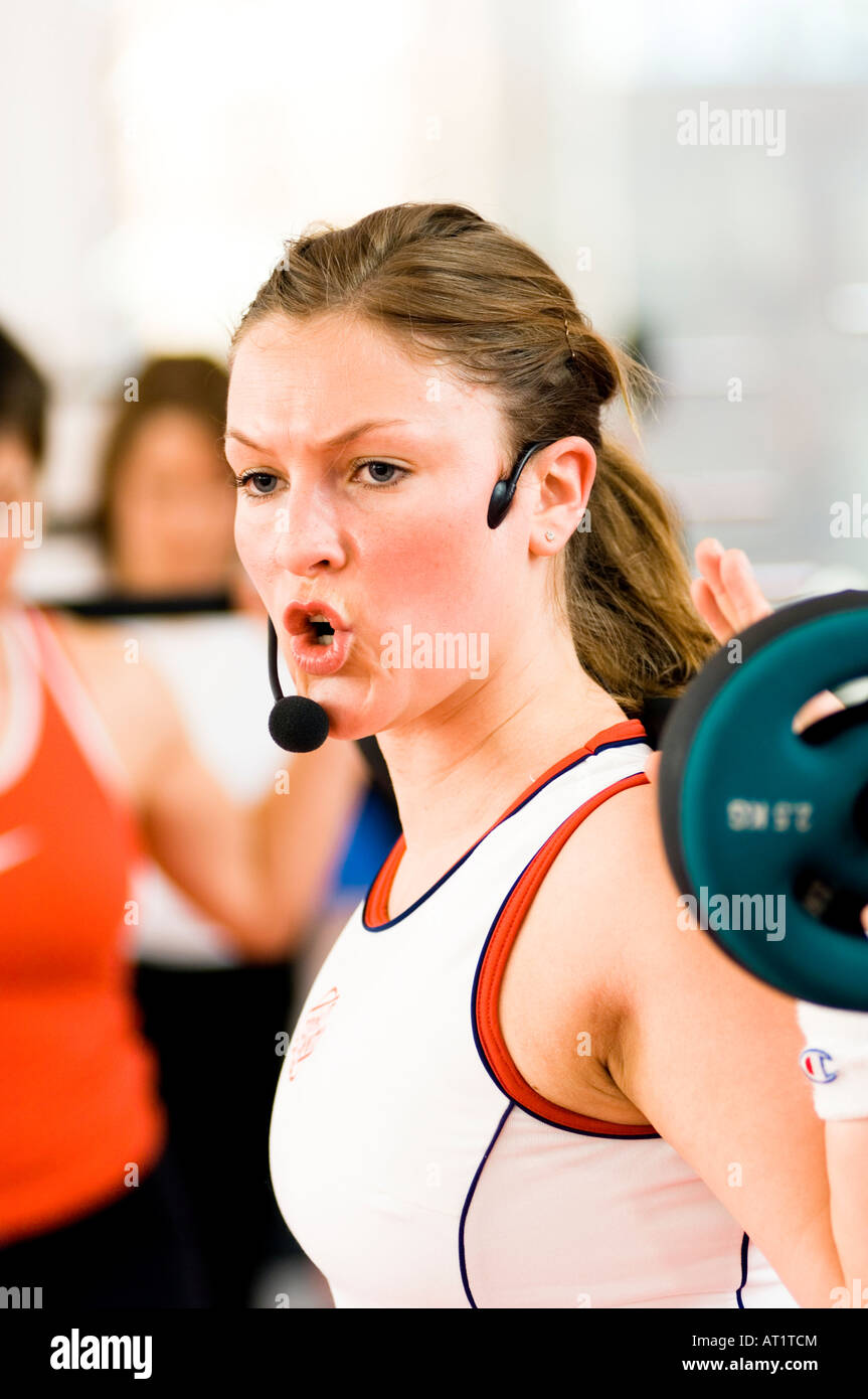 Female aerobics trainer showing bodytoning with light weights Stock ...