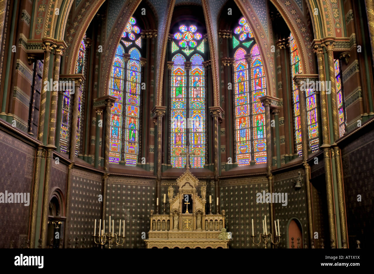 The golden altar and the richly decorated stone wall of the apse of ...