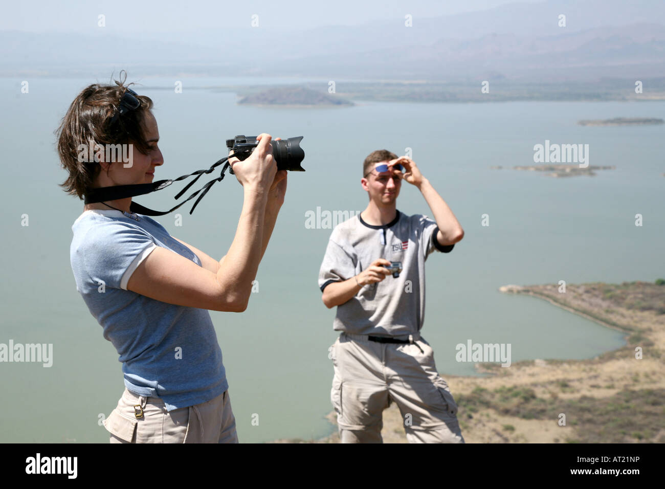 Western tourists on African overlook taking pictures of the landscape ...